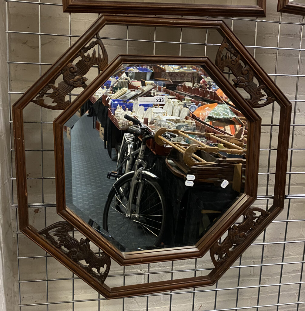 OCTAGONAL MIRROR WITH CARVED BATS TO FRAME - Southgate Auction Rooms