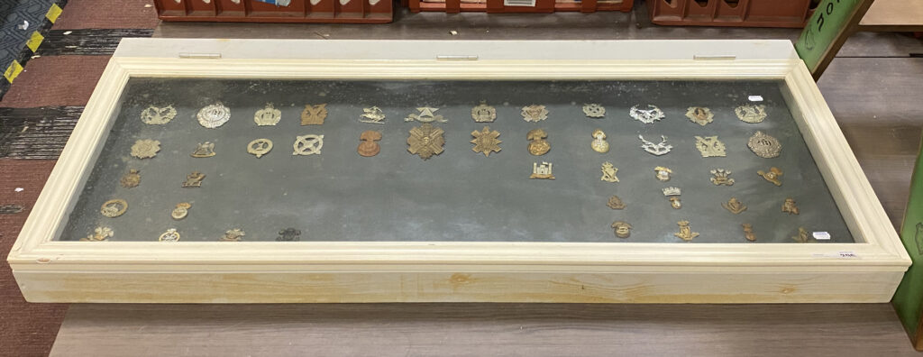 DISPLAY CABINET WITH MILITARY CAP BADGES - Southgate Auction Rooms